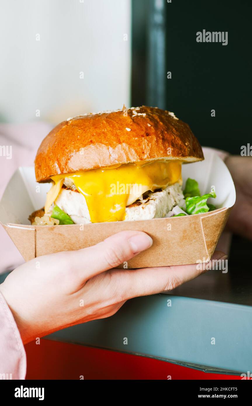 Freshly prepared cheeseburger in a paper box. Takeaway or delivery ...