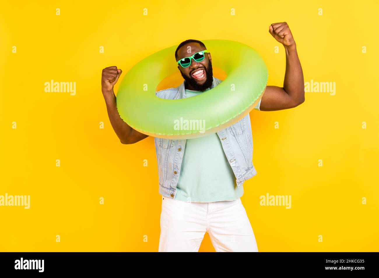 Portrait of attractive trendy cheerful guy wearing life buoy having fun ...