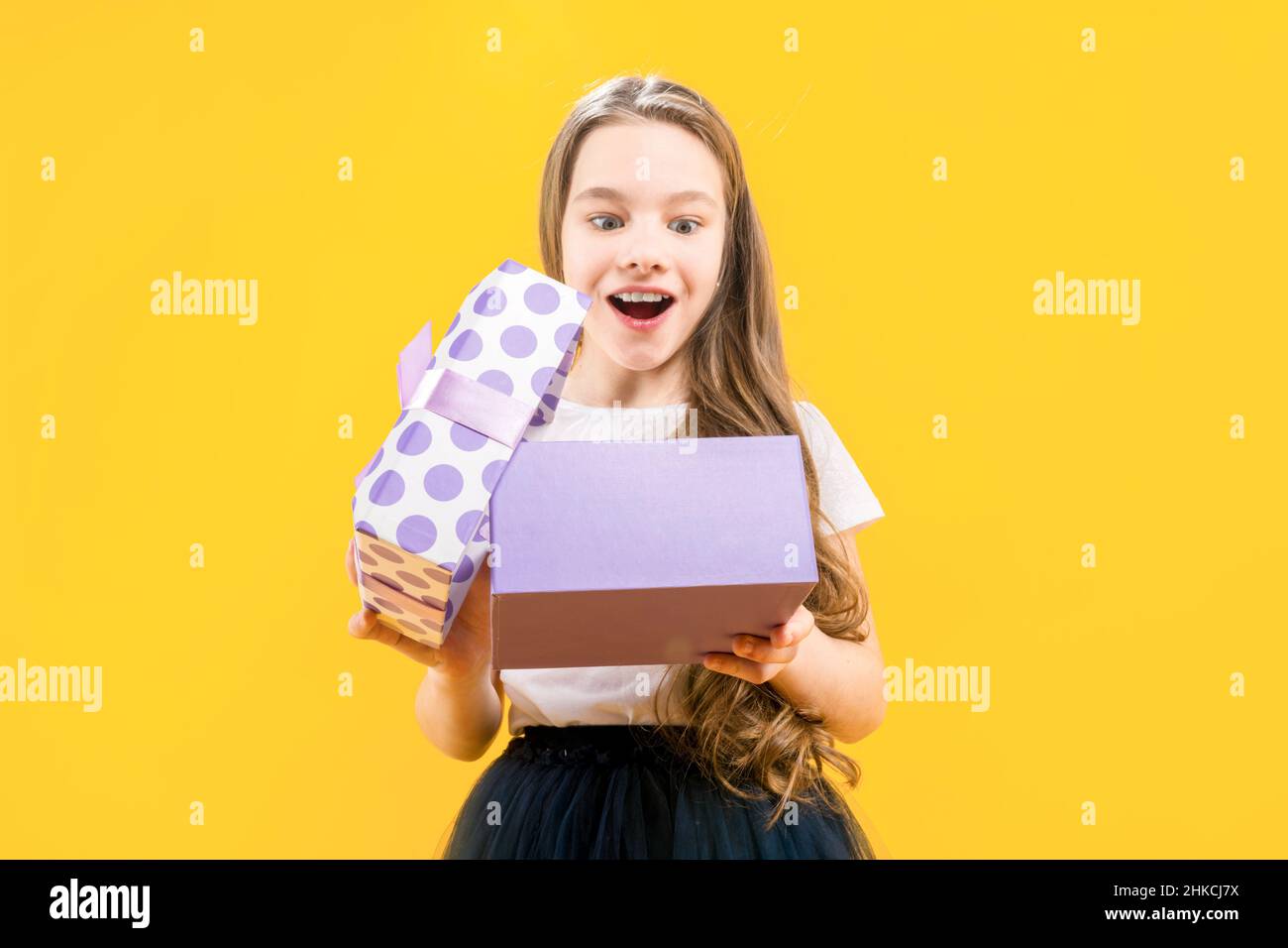 Congratulations. Gift wrap. A cute girl in a white t-shirt and black ...