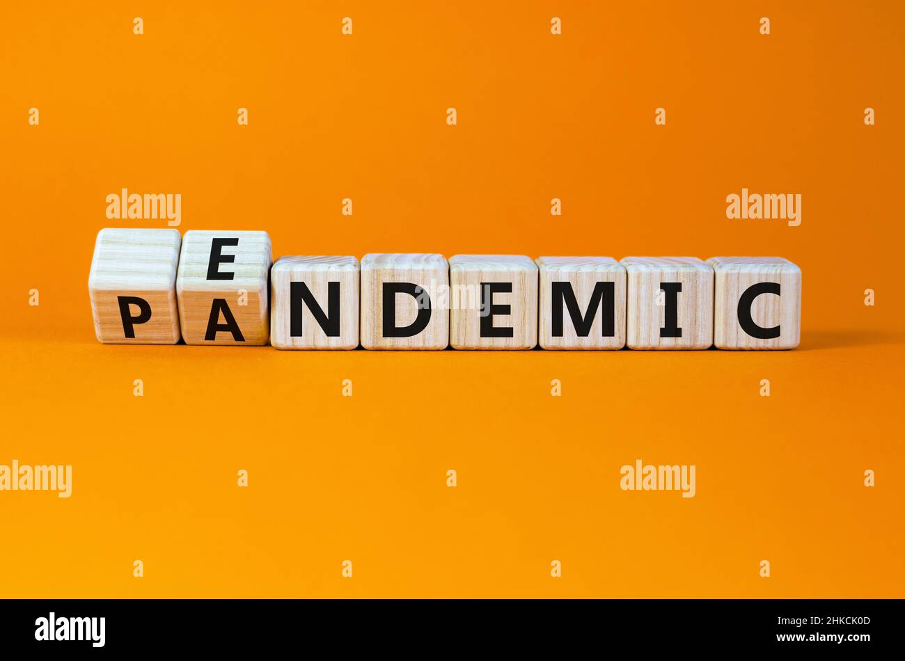 Covid-19 pandemic or endemic symbol. Turned wooden cubes and changed ...