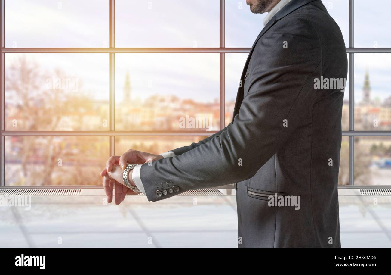 Businessman watching the time at his smartwatch in the office Stock ...