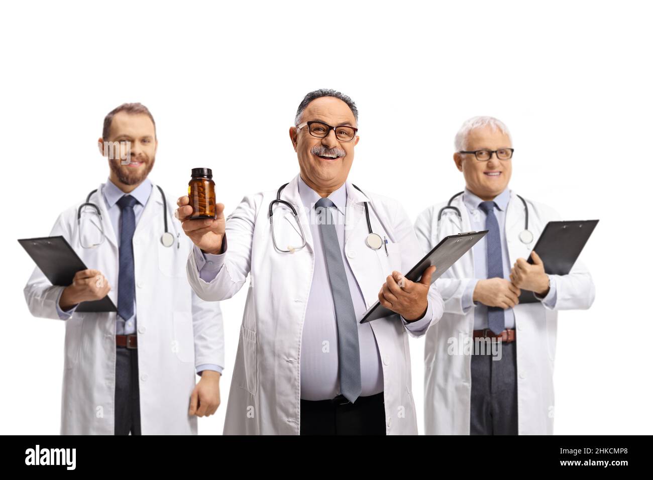 Team of male doctors showing a bottle of pills isolated on white ...