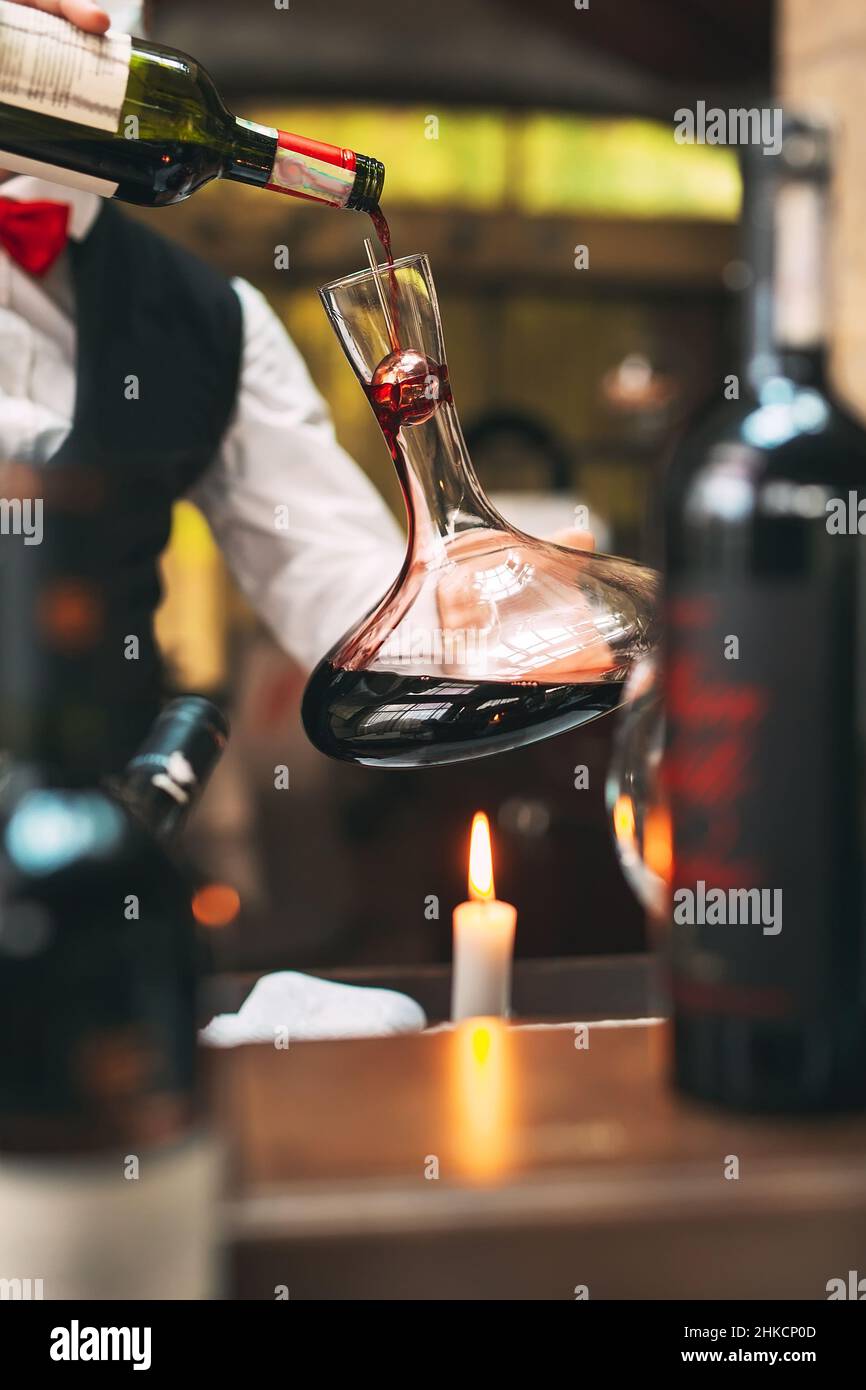 The sommelier is decanting wine in the restaurant Stock Photo - Alamy