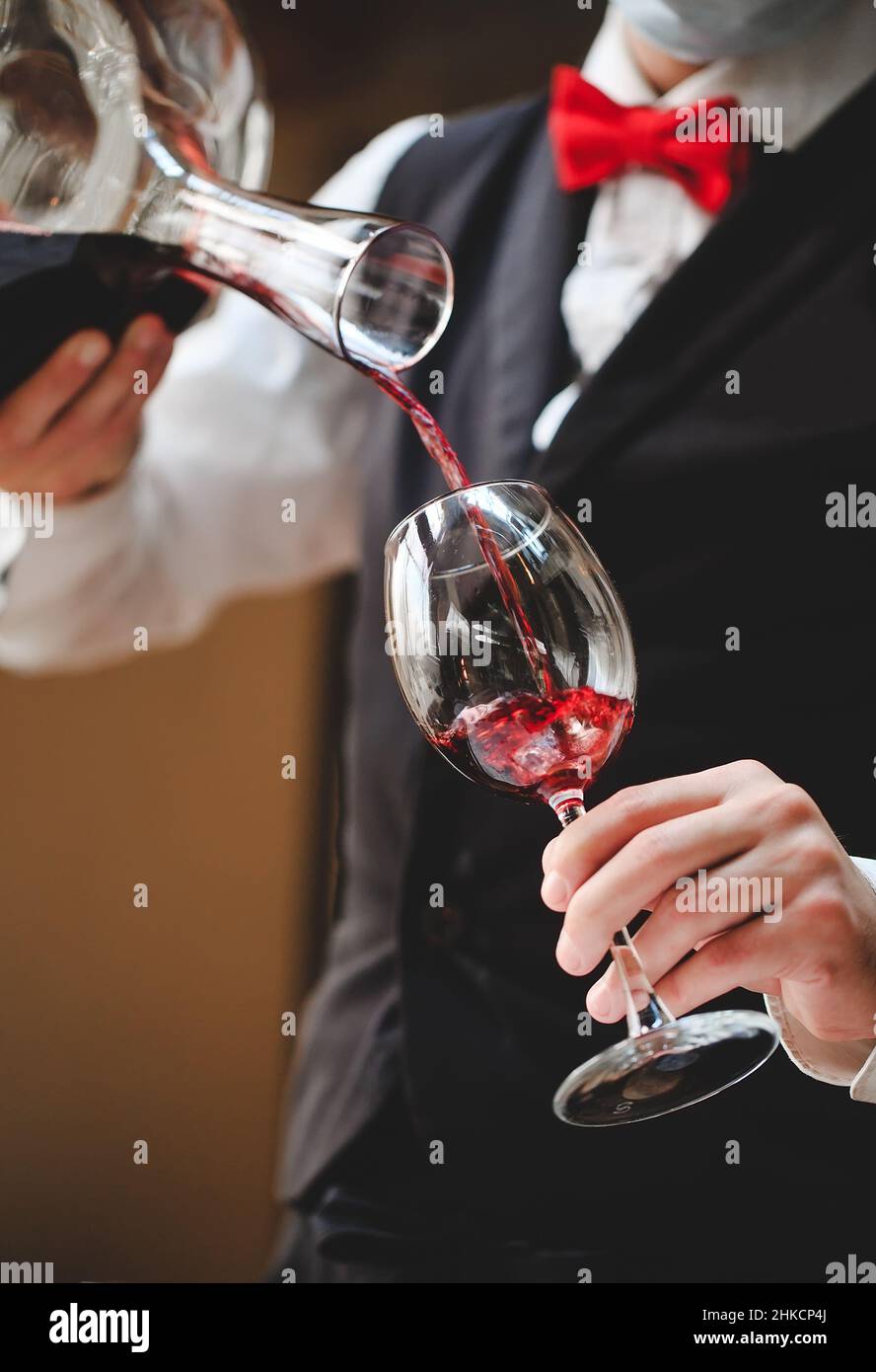 The sommelier is decanting wine in the restaurant Stock Photo - Alamy