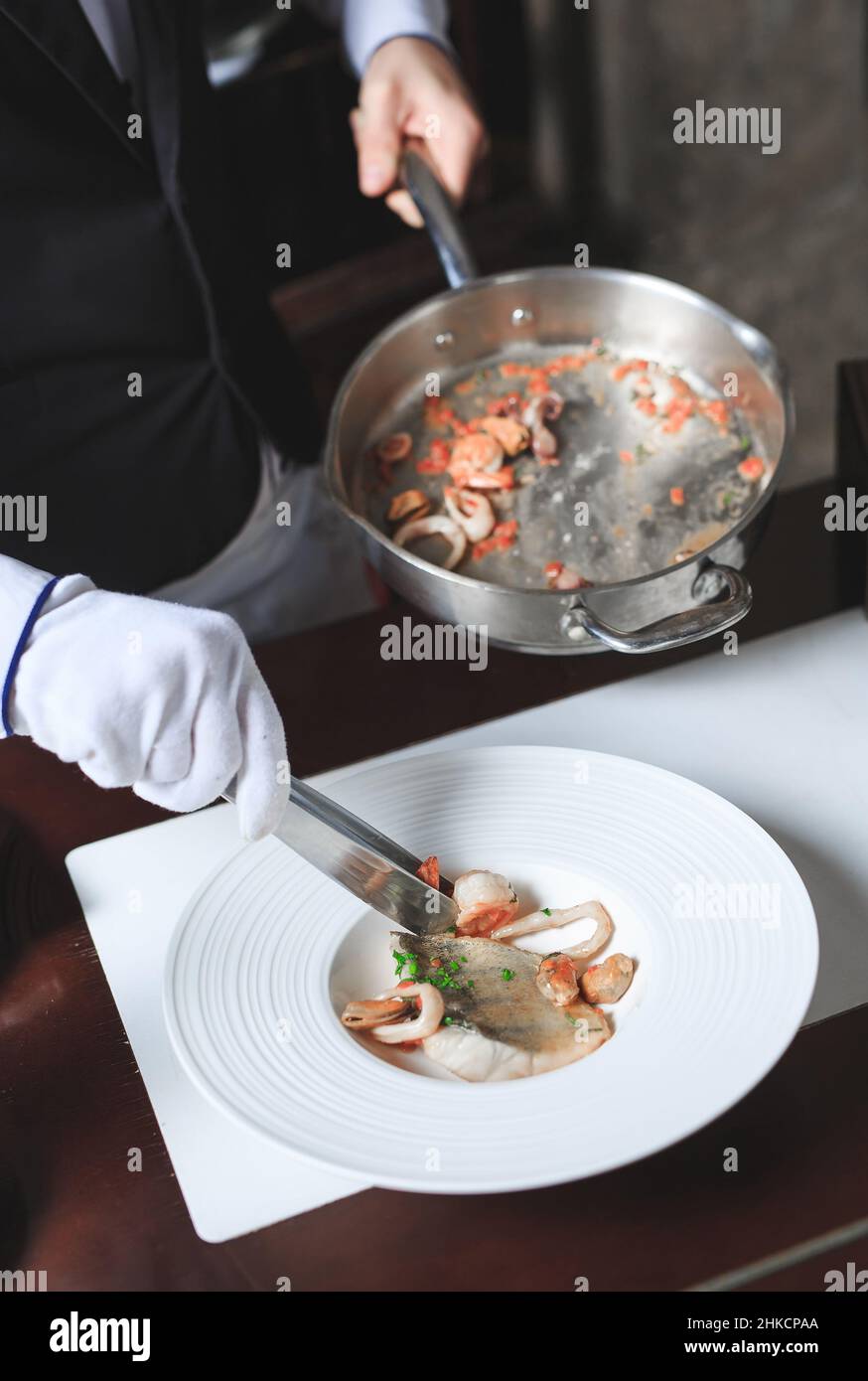 Hand chef in gloves puts hi-res stock photography and images - Alamy