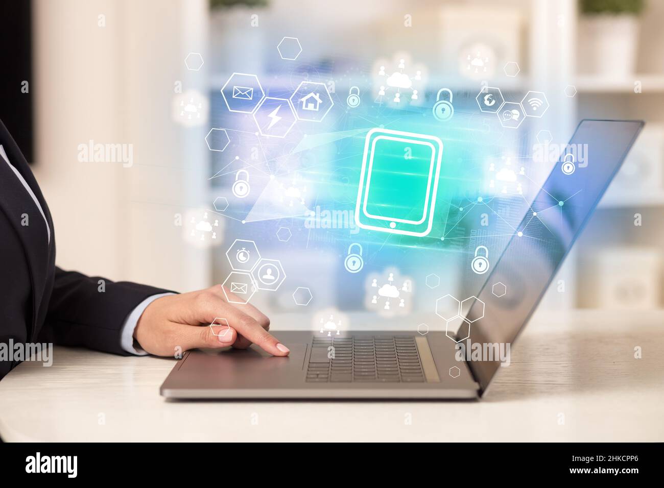 Hands working on laptop with digital icons Stock Photo - Alamy