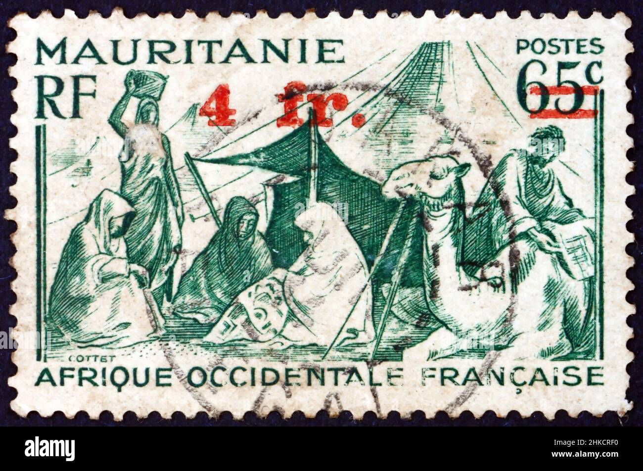 MAURITANIA - CIRCA 1938: a stamp printed in Mauritania shows family ...