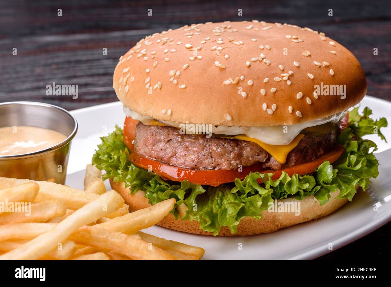 Craft beef burger and french fries on a dark table Stock Photo - Alamy
