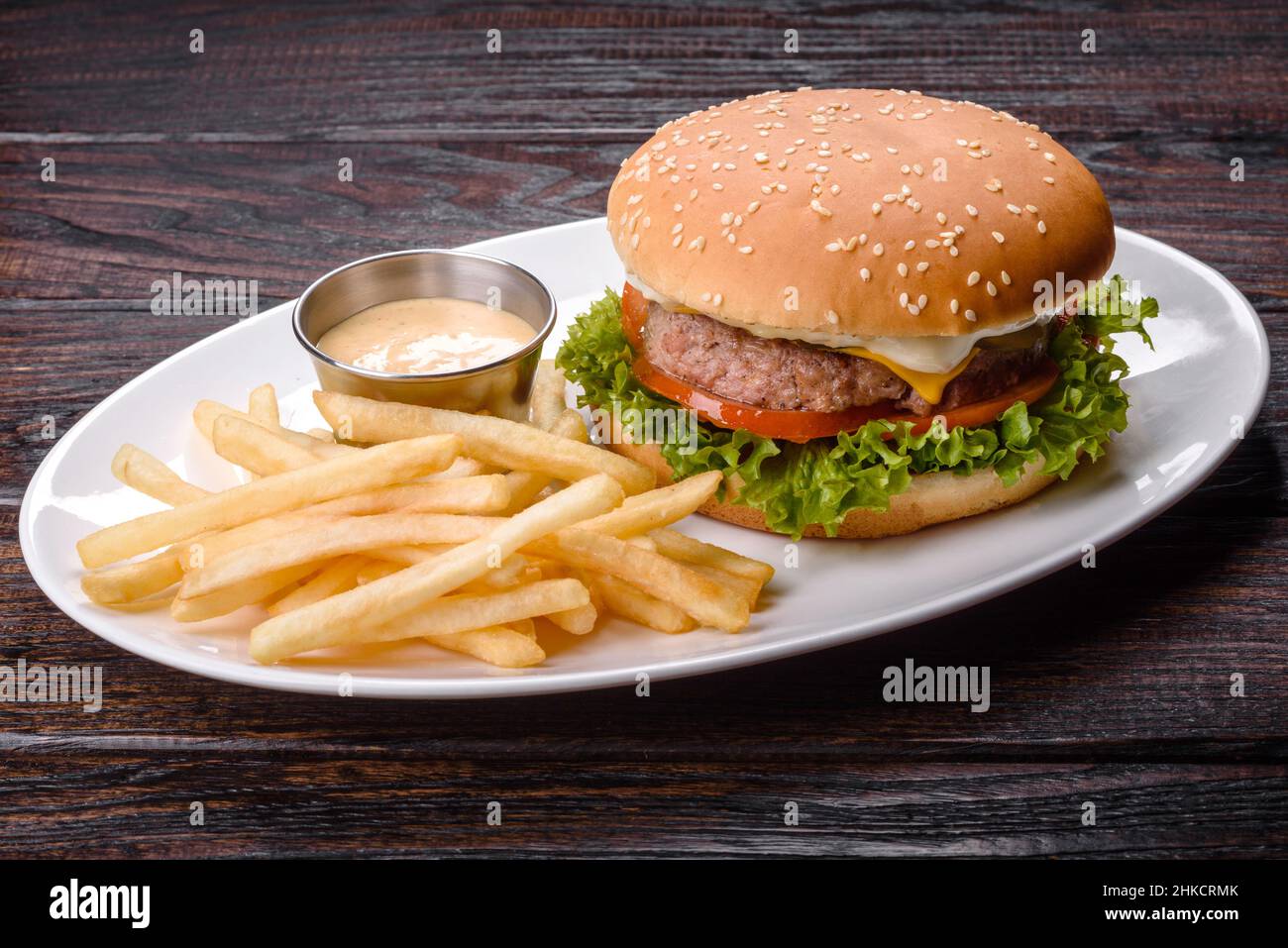 Craft beef burger and french fries on a dark table Stock Photo - Alamy