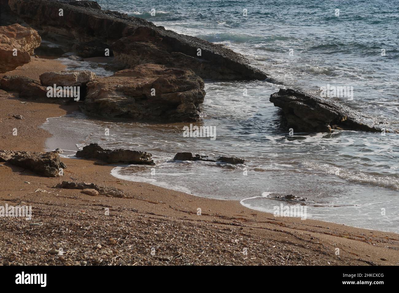 Rocks and sand on a beach in Cyprus Stock Photo - Alamy