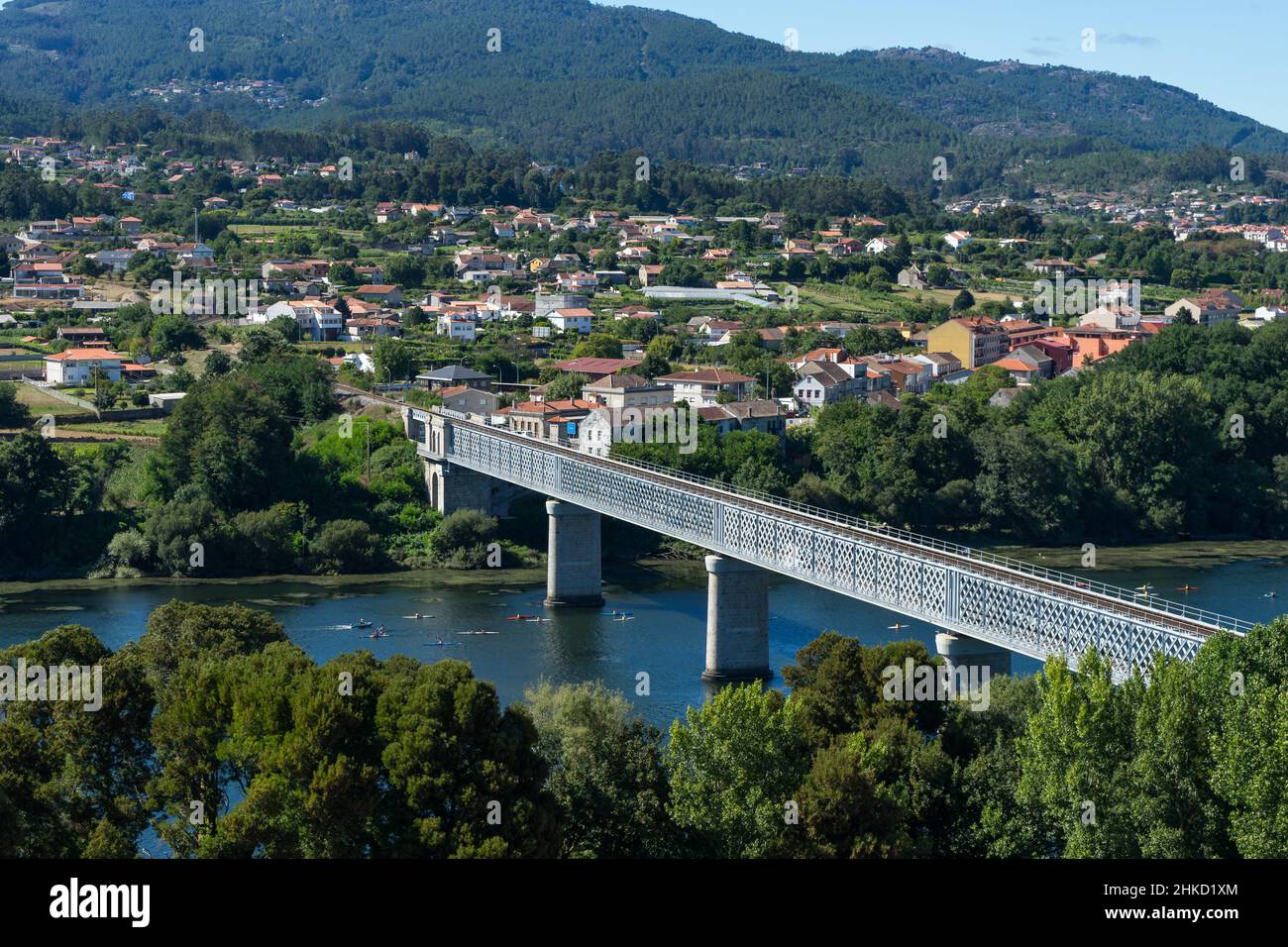 View of small town with river and a metal bridge Stock Photo - Alamy