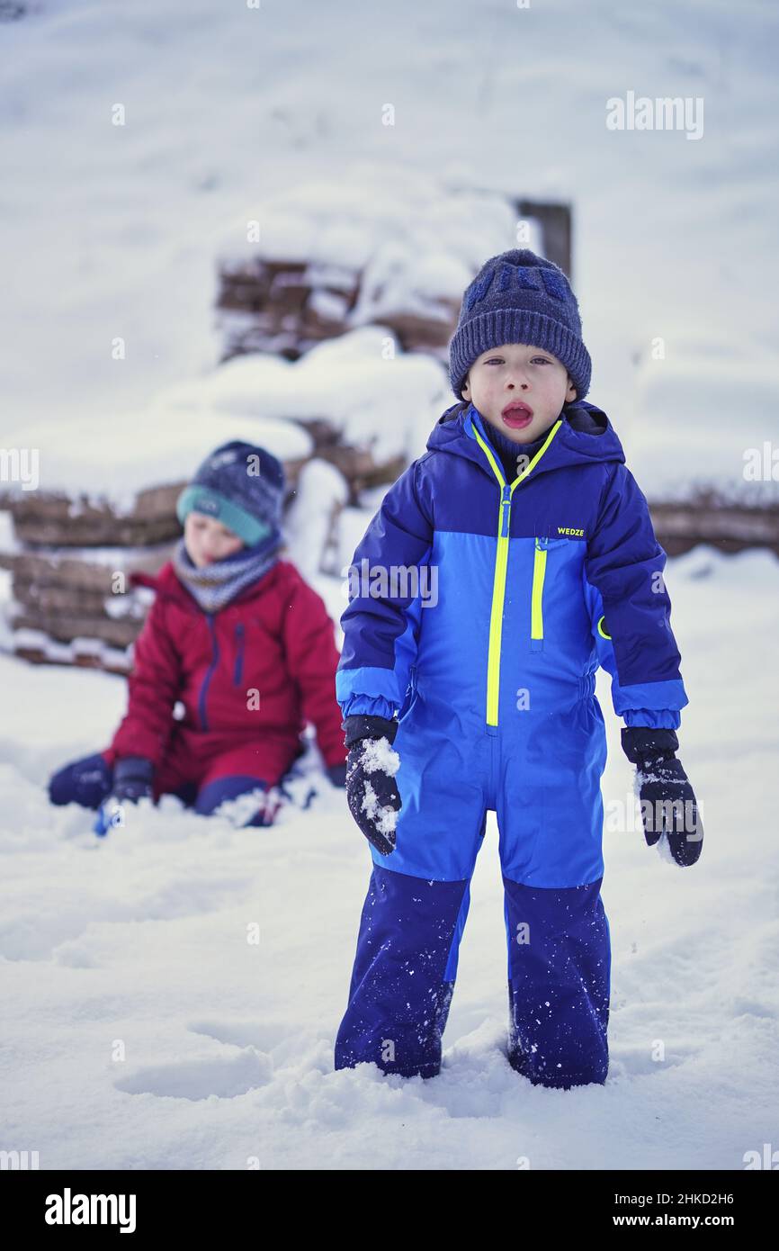 Two boys playing with snow Stock Photo - Alamy