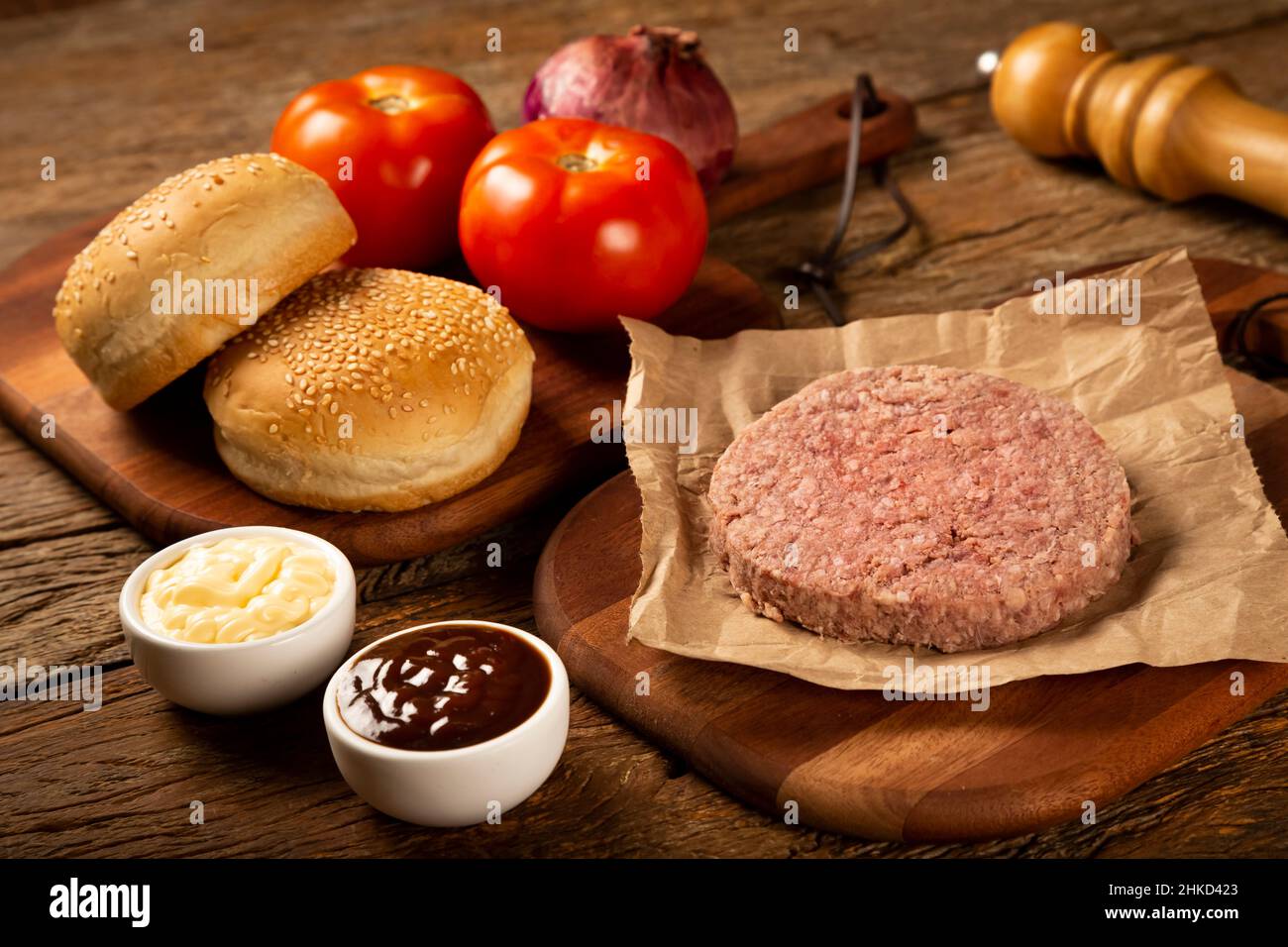 Table with ingredients for hamburger. Raw hamburger Stock Photo - Alamy