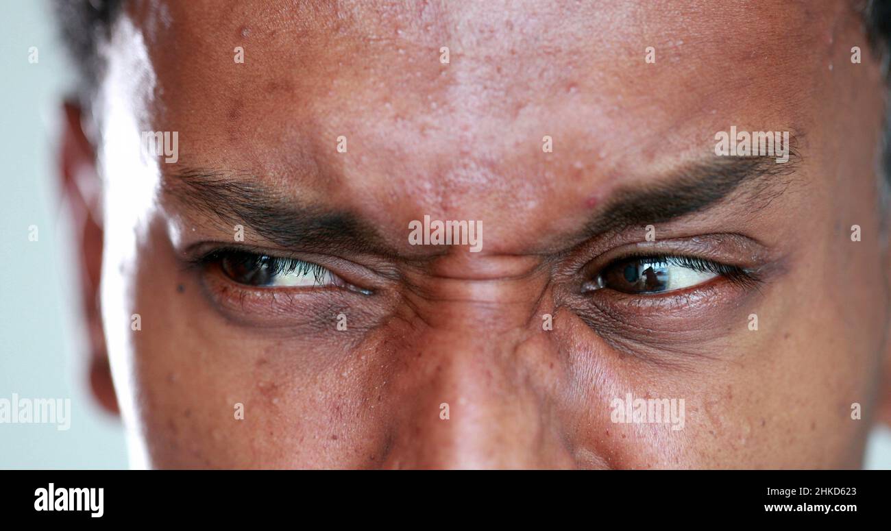 African man eyes squinting. Close-up black guy closing eyes squint ...