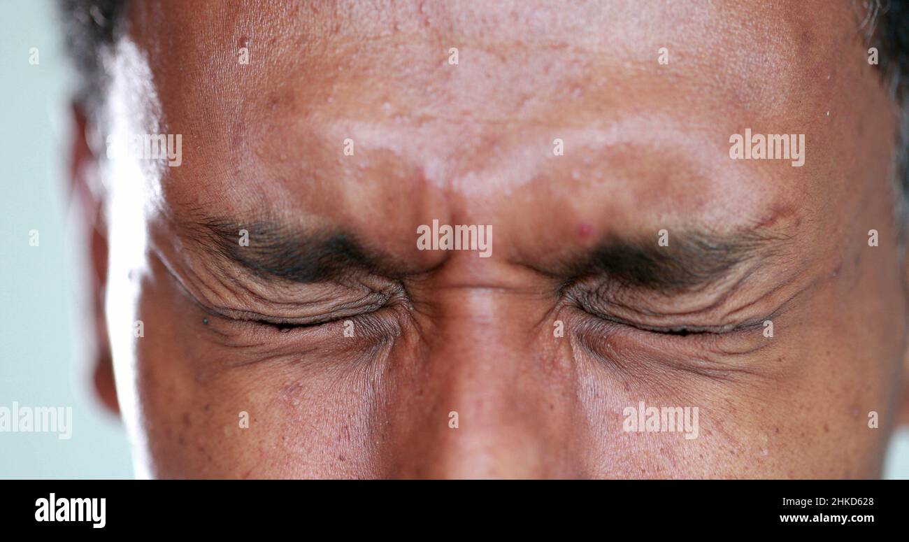 African man eyes squinting. Close-up black guy closing eyes squint ...