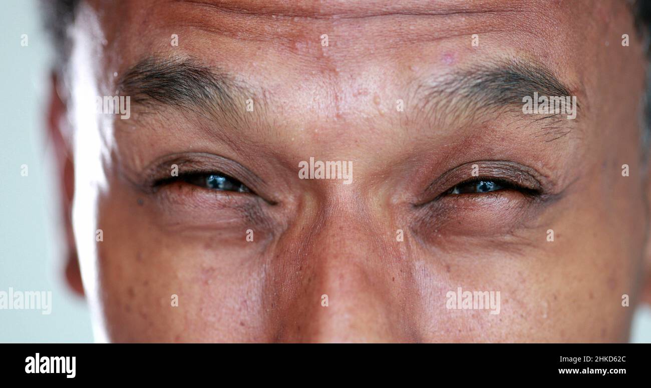 African man eyes squinting. Close-up black guy closing eyes squint ...