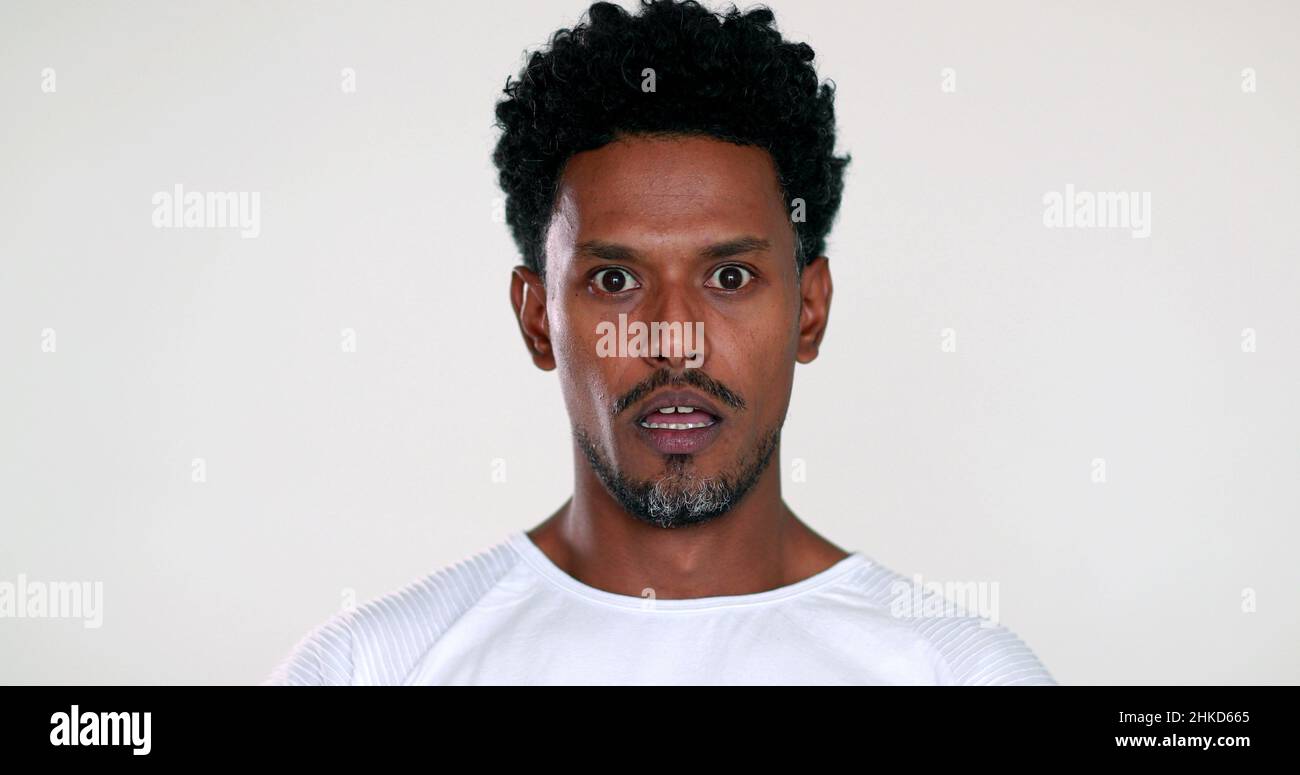 African man reacting shock surprise tense reaction face emotion Stock ...