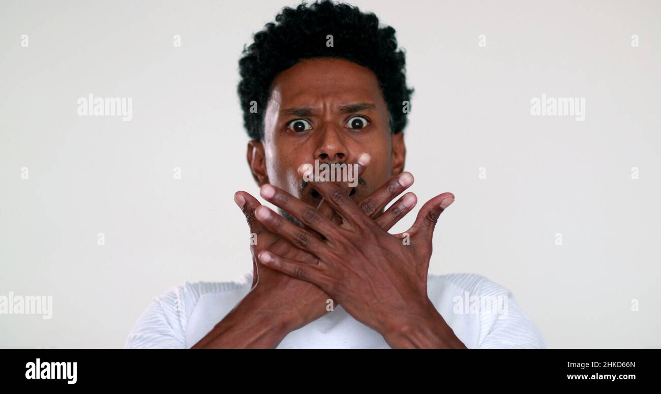 African man reacting with terror and horror to camera, black guy shock reaction Stock Photo - Alamy