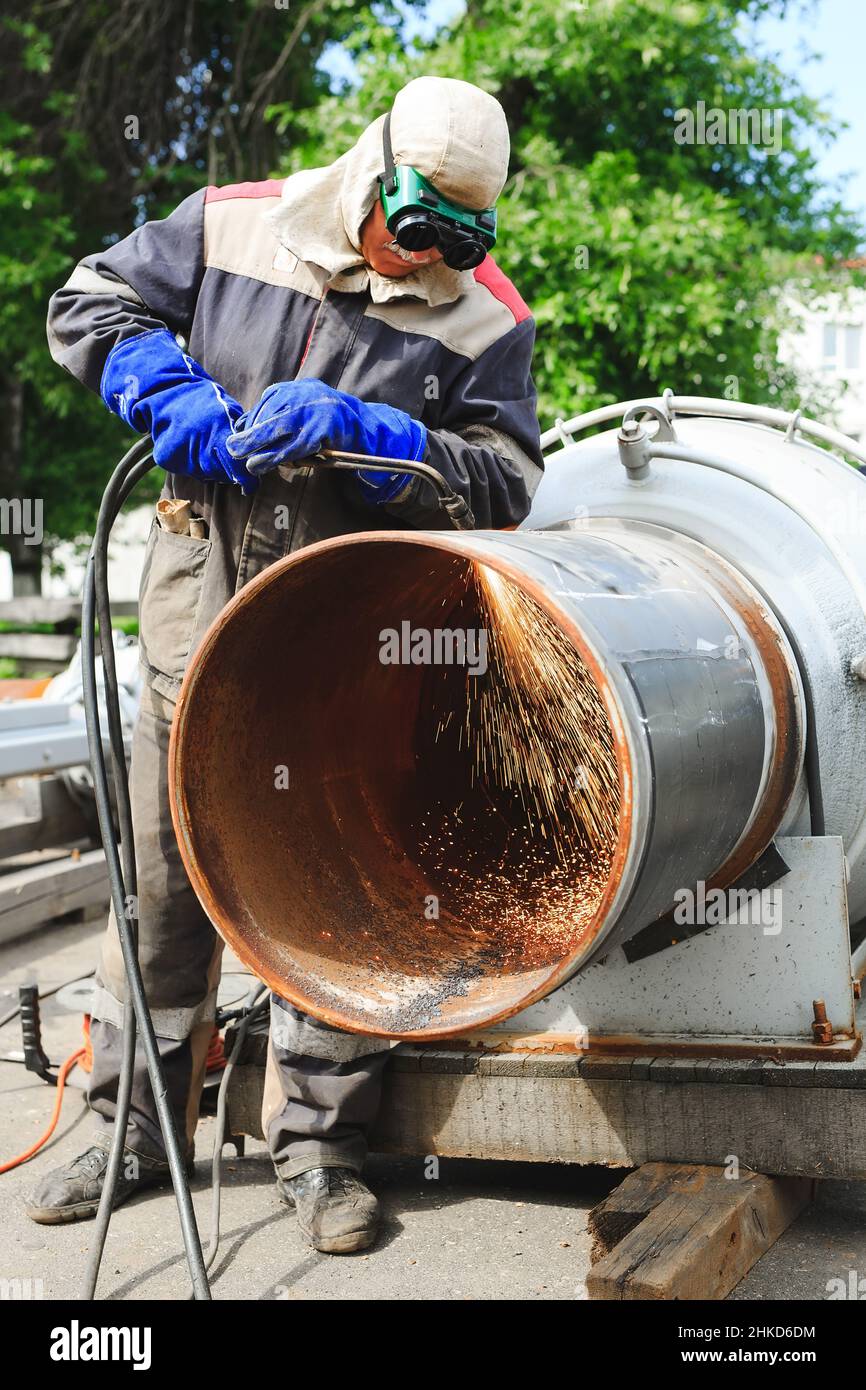 The welder cuts large metal pipes with ocetylene welding Stock Photo ...