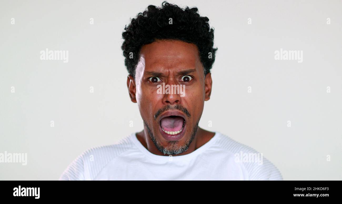 Black man reacting with SHOCK and TERROR to bad news Stock Photo - Alamy