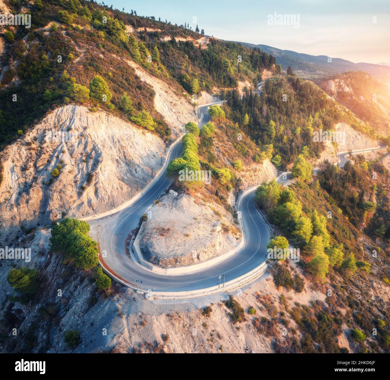 Aerial view of mountain road, green forest at sunset in summer Stock ...