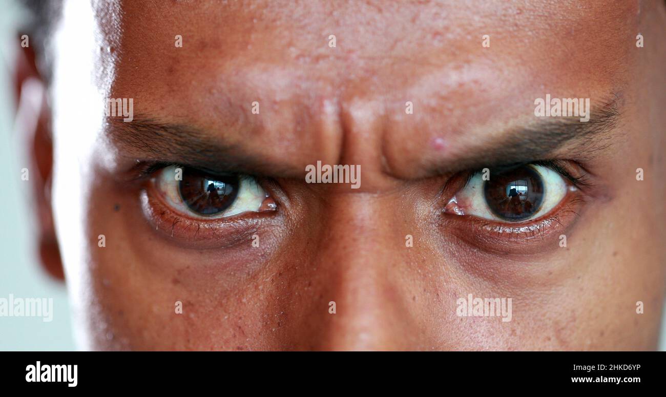 Man has a serious look on his face. Closeup of man frowning and with an ...