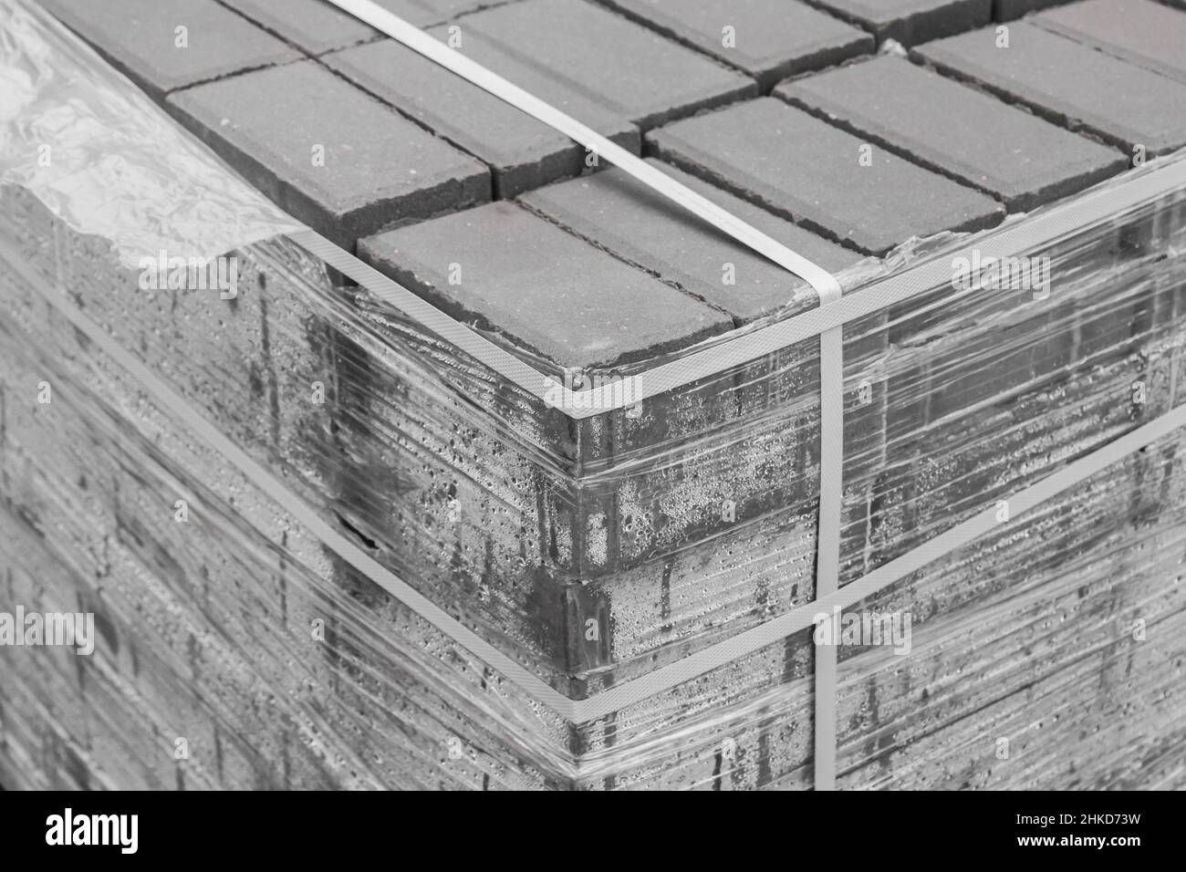 Stone pavement blocks in a pile of tiles building material packed in ...