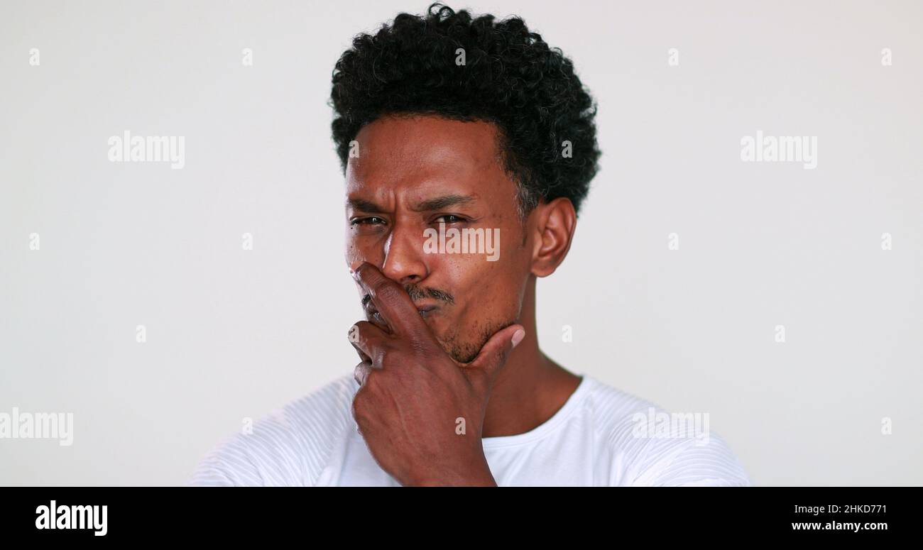 Pensive African American man portrait looking to camera deciding ...
