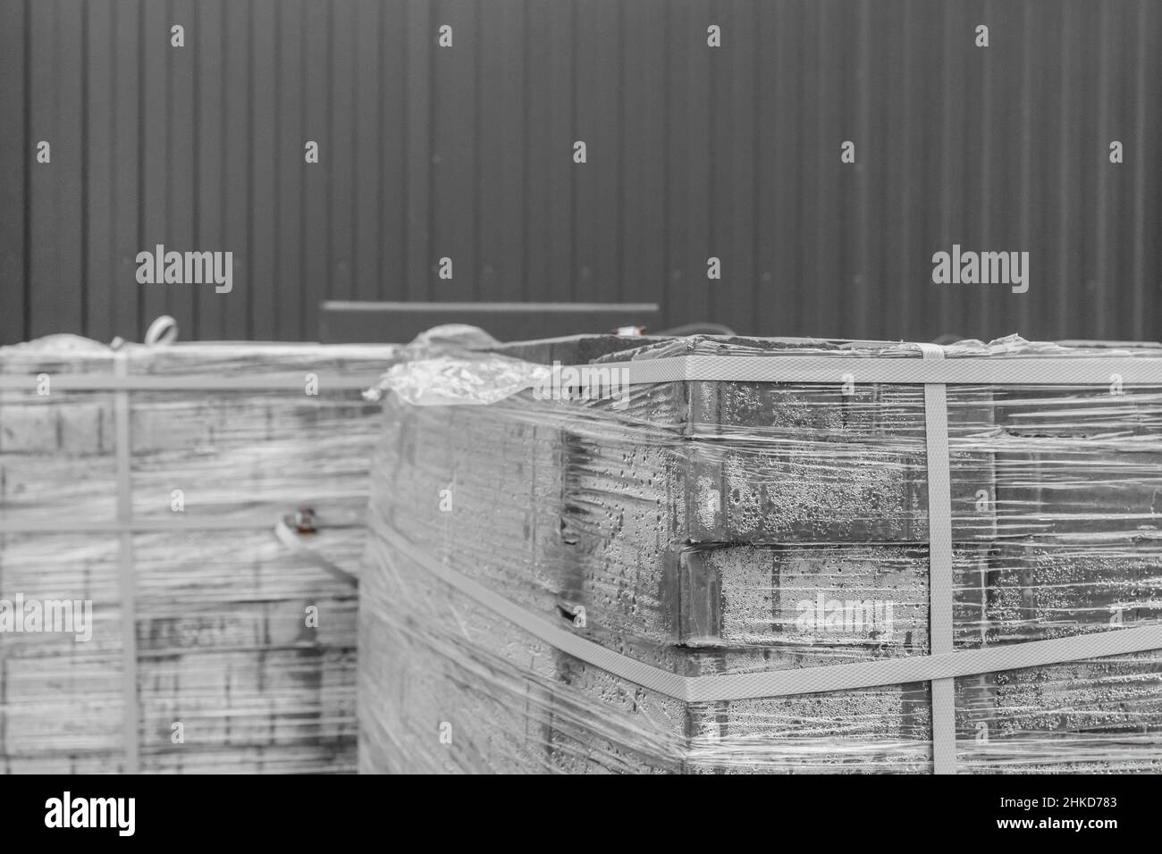 Stone pavement blocks in a pile of tiles building material packed in ...