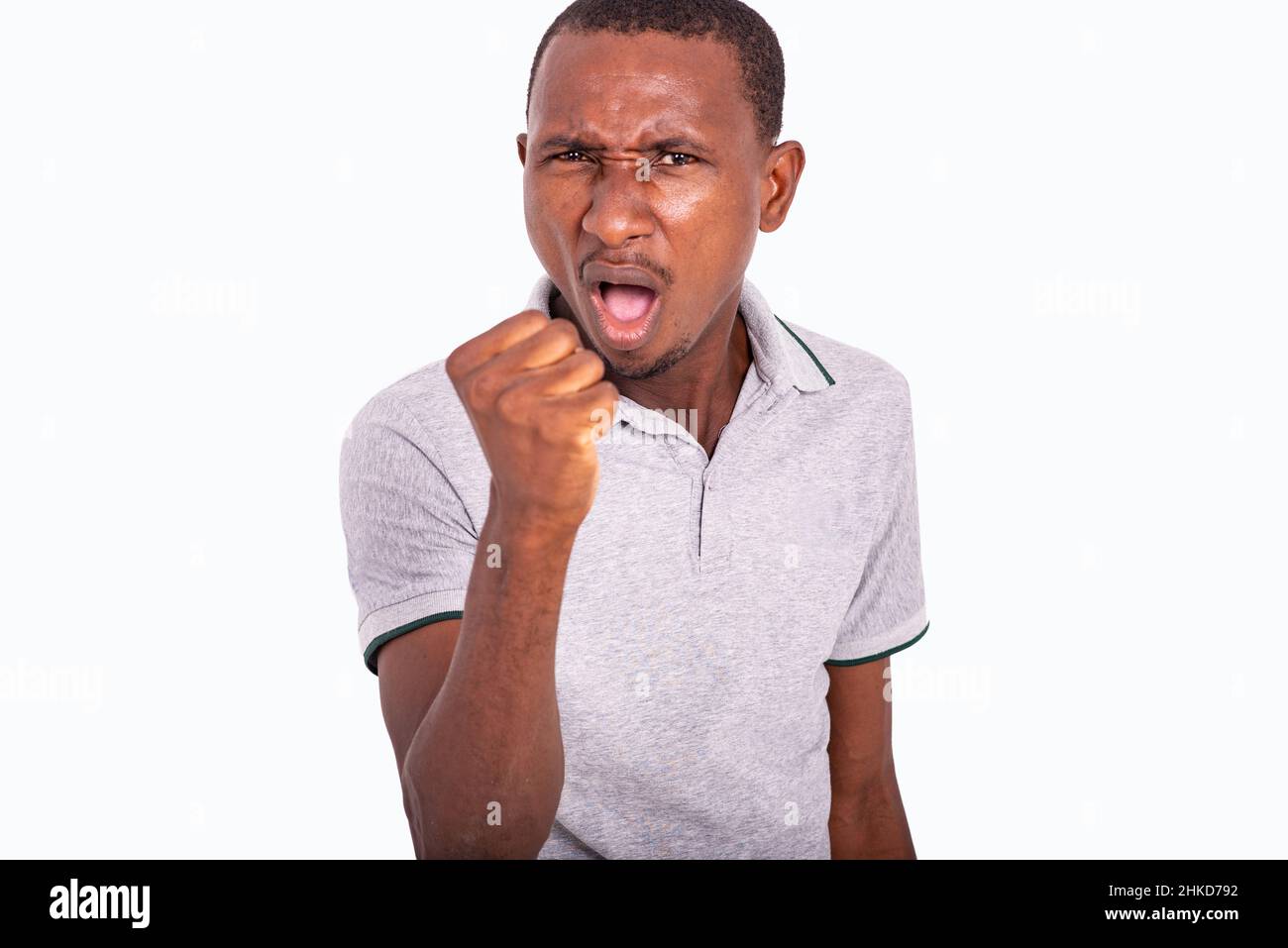 angry furious adult man raising his fist isolated on white background ...