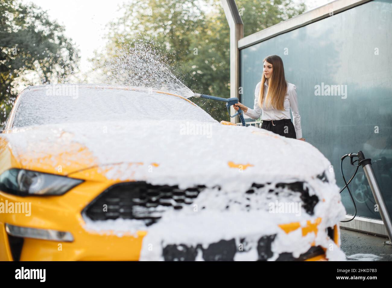 Washing of modern car on open air self car wash service with foam and ...