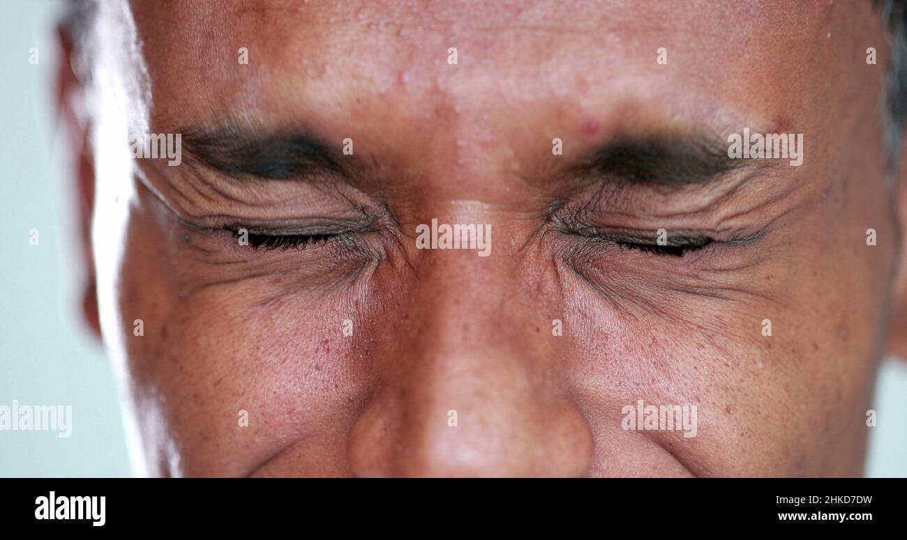 Person close-up eyes closed feeling upset feeling emocional, squinting eyesight Stock Photo - Alamy