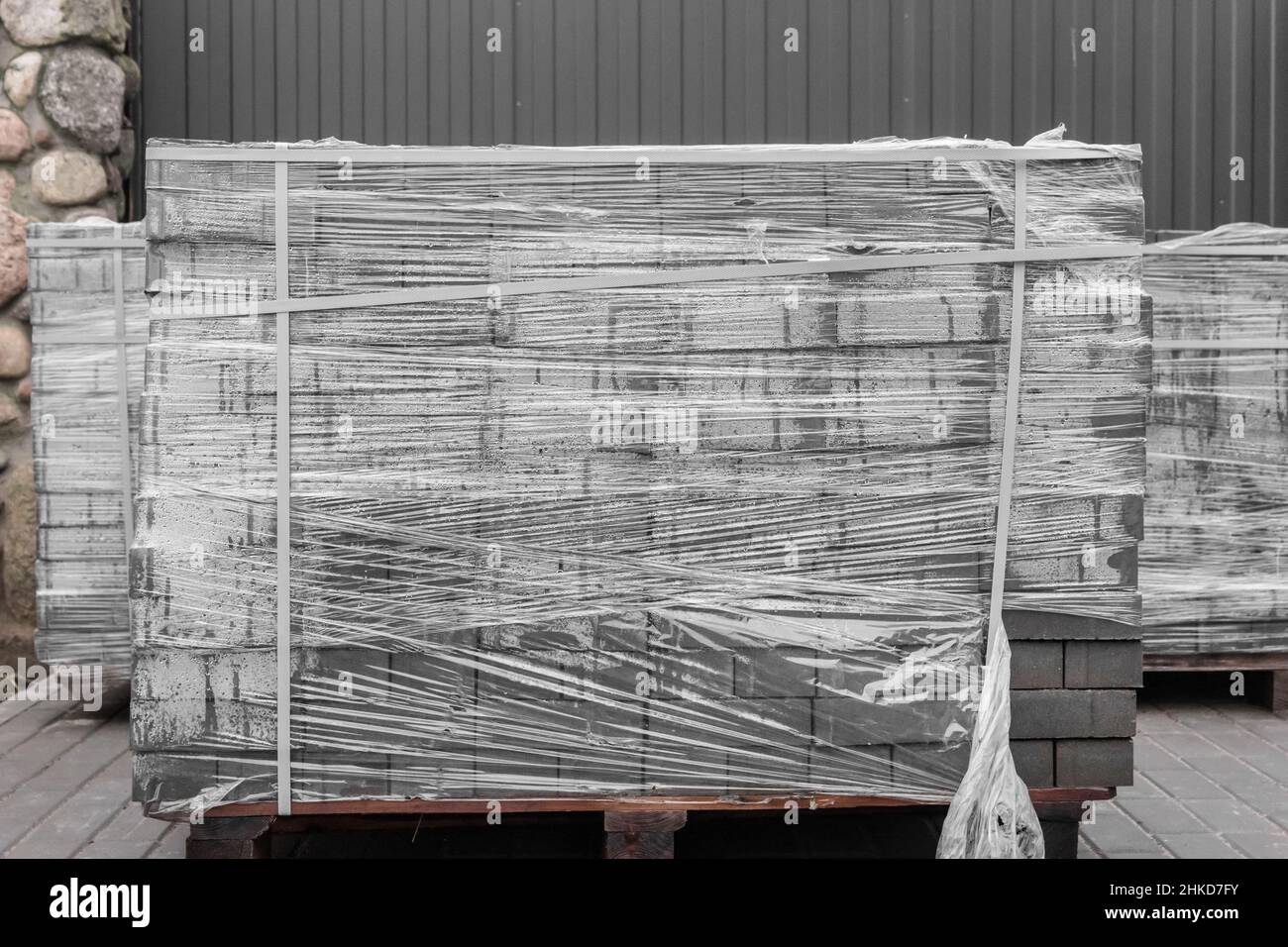 Stone pavement blocks in a pile of tiles building material packed in ...