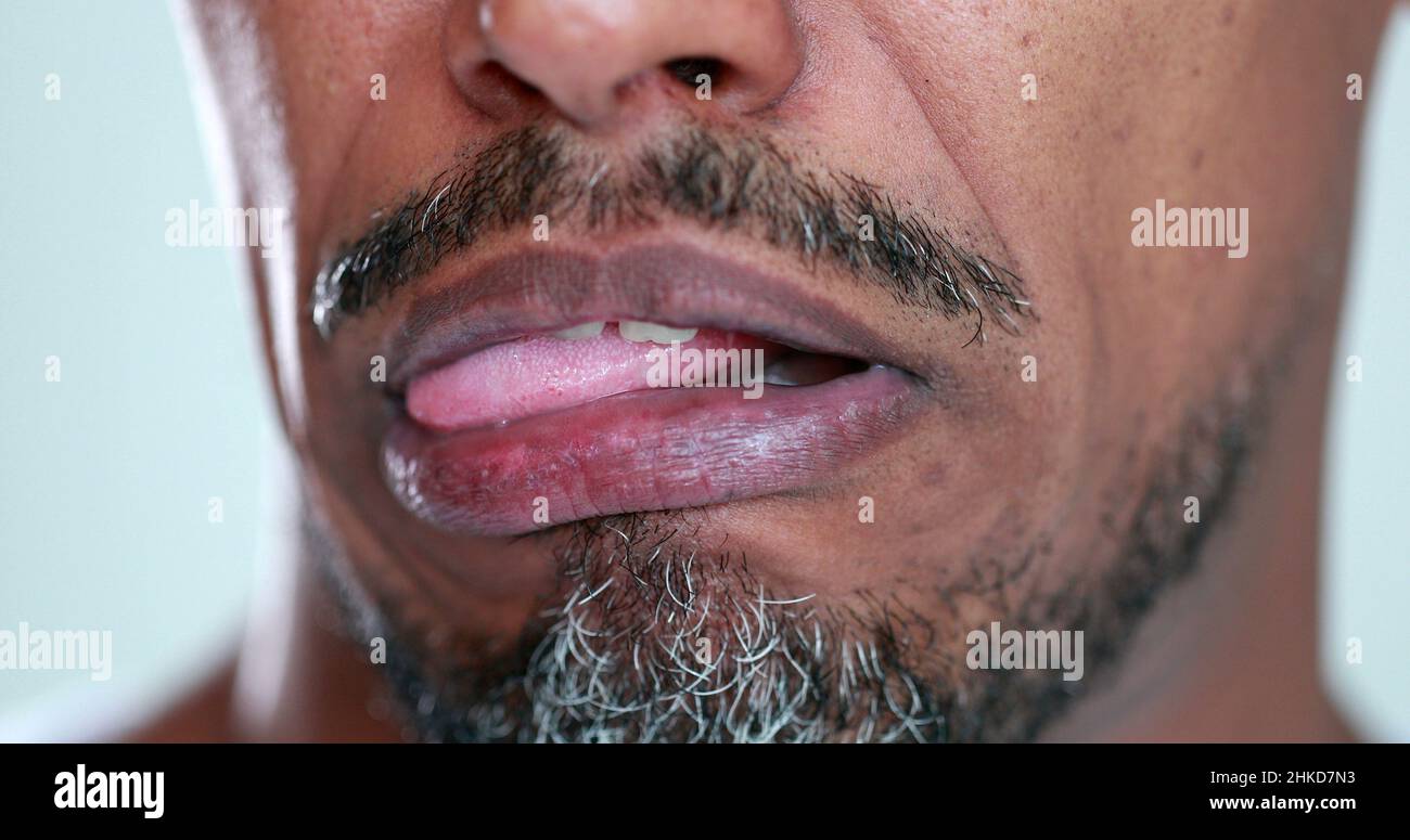 Person mouth close-up feeling disgust, mixed race man disliking emotion ...