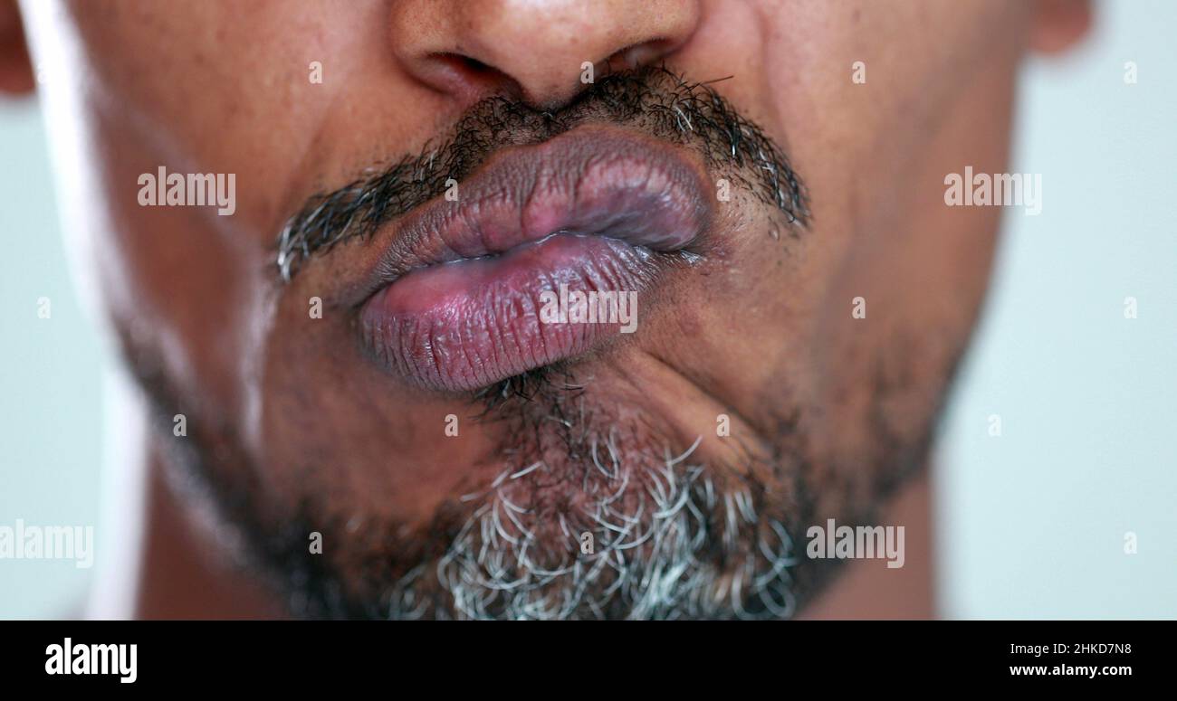 Person mouth close-up feeling disgust, mixed race man disliking emotion ...