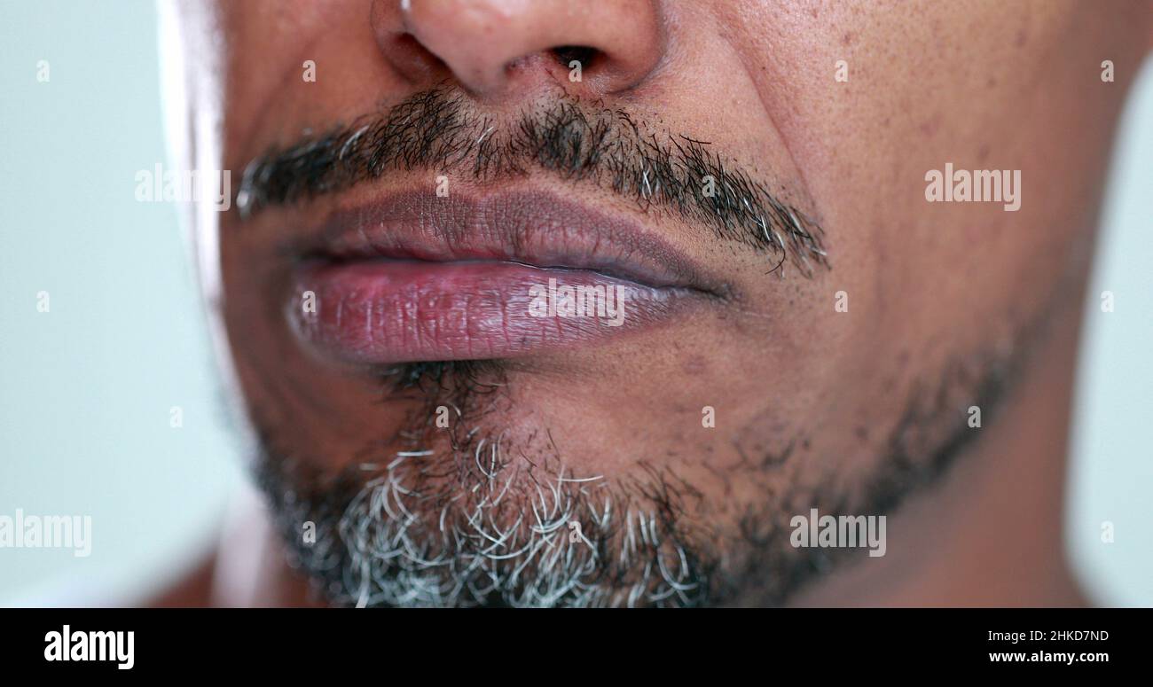 Person mouth close-up feeling disgust, mixed race man disliking emotion ...