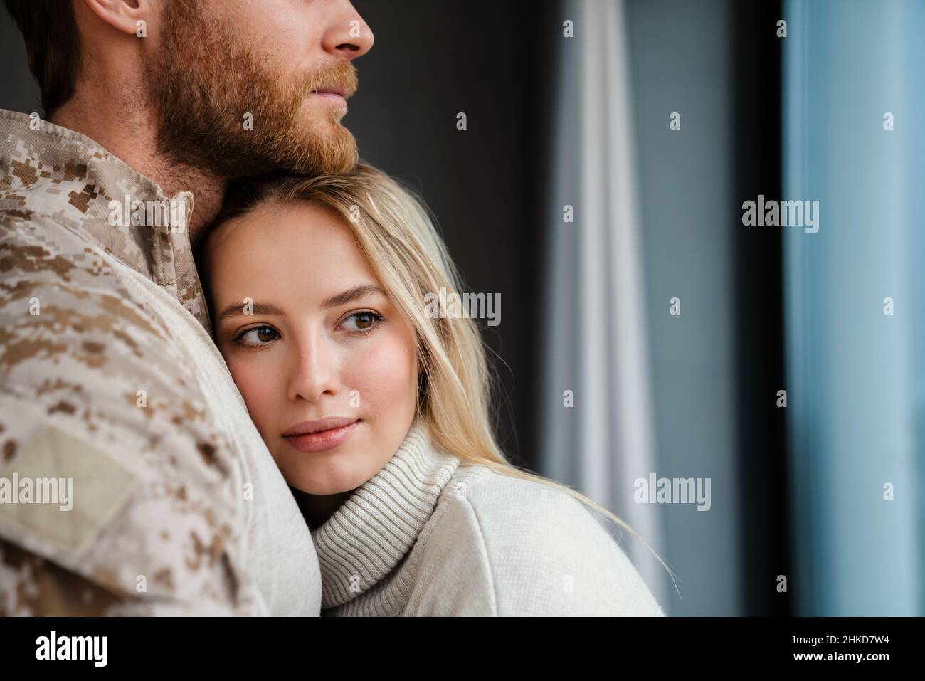 Beautiful Romantic Couple Hugging While Standing Near Window Indoors