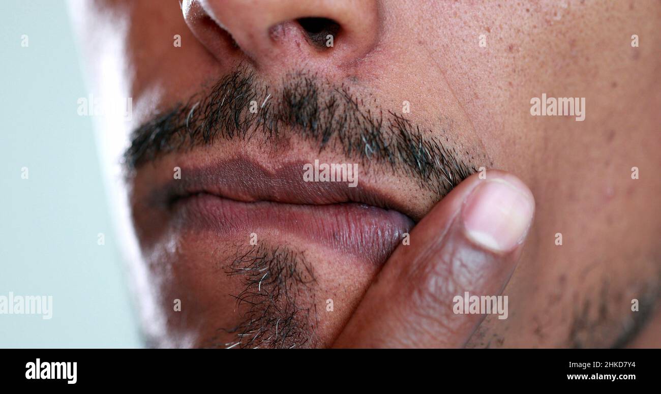 Person touching mouth and face with hand, close-up person fidgeting ...