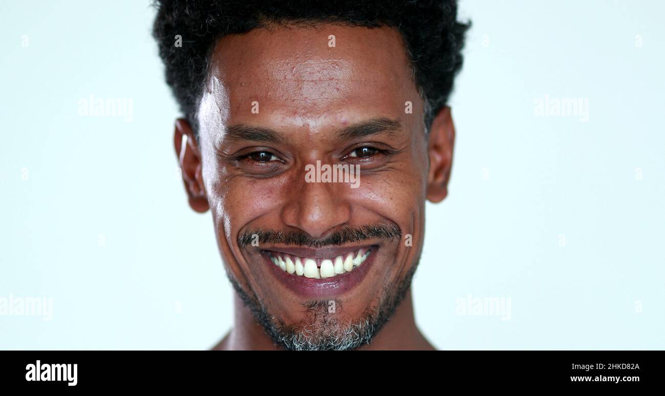 Portrait african man taking a deep breath opening eyes smiling and ...
