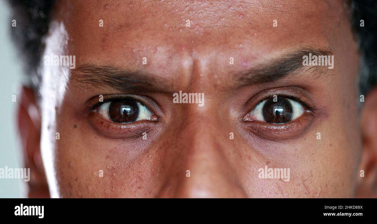 Surprised African descent close-up eyes reaction, looking to camera ...