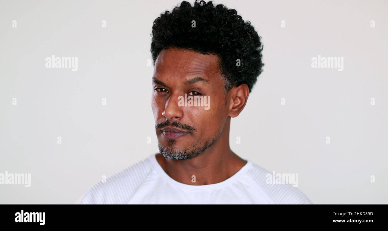 Suspicious black African man reaction to camera. Portrait guy reacting ...