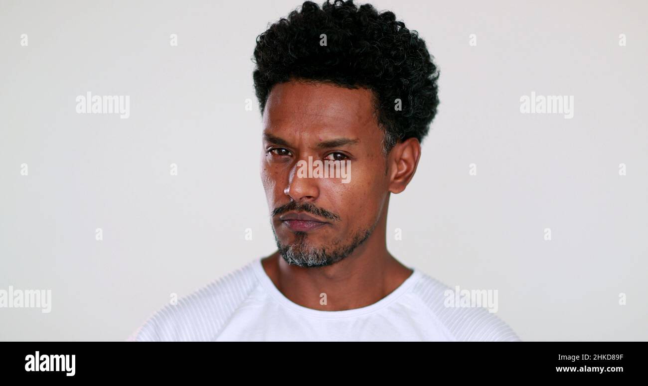 Suspicious black African man reaction to camera. Portrait guy reacting ...