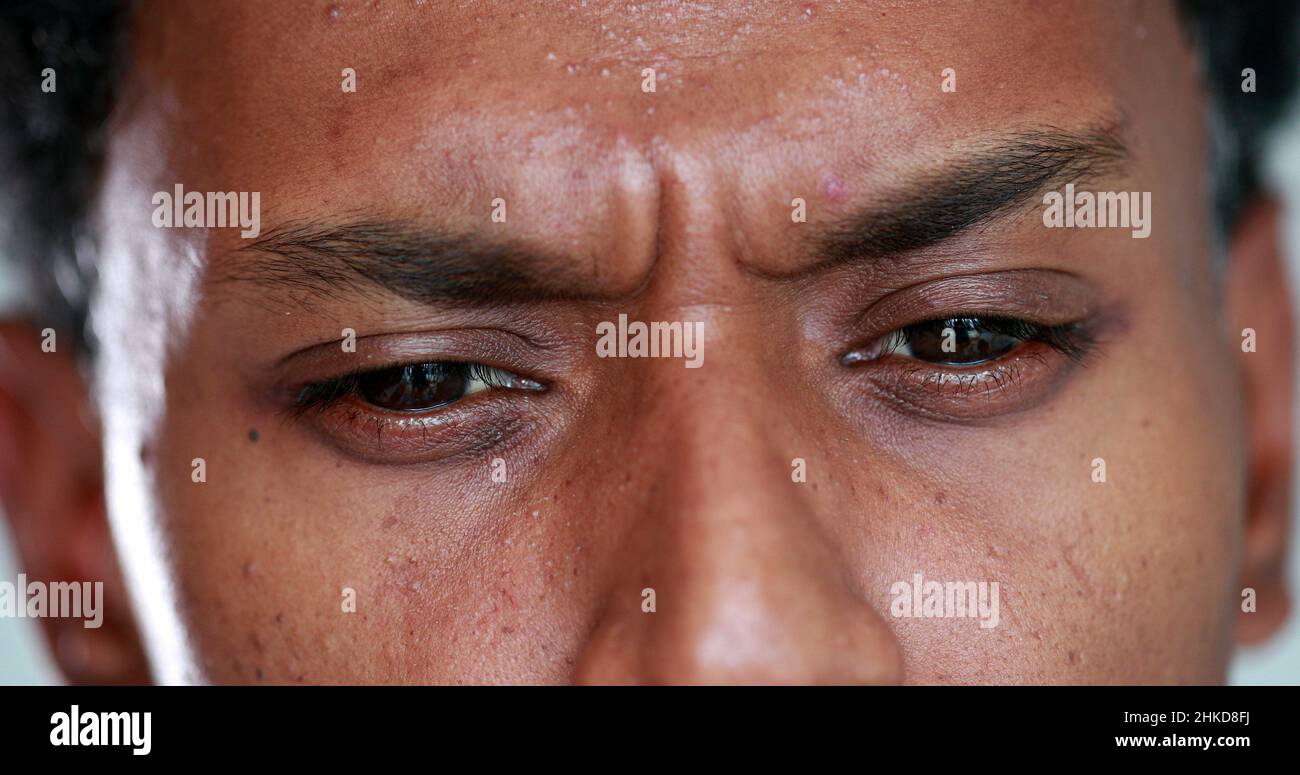 Worried african man closeup eyes squinting, concerned preoccupied black ...