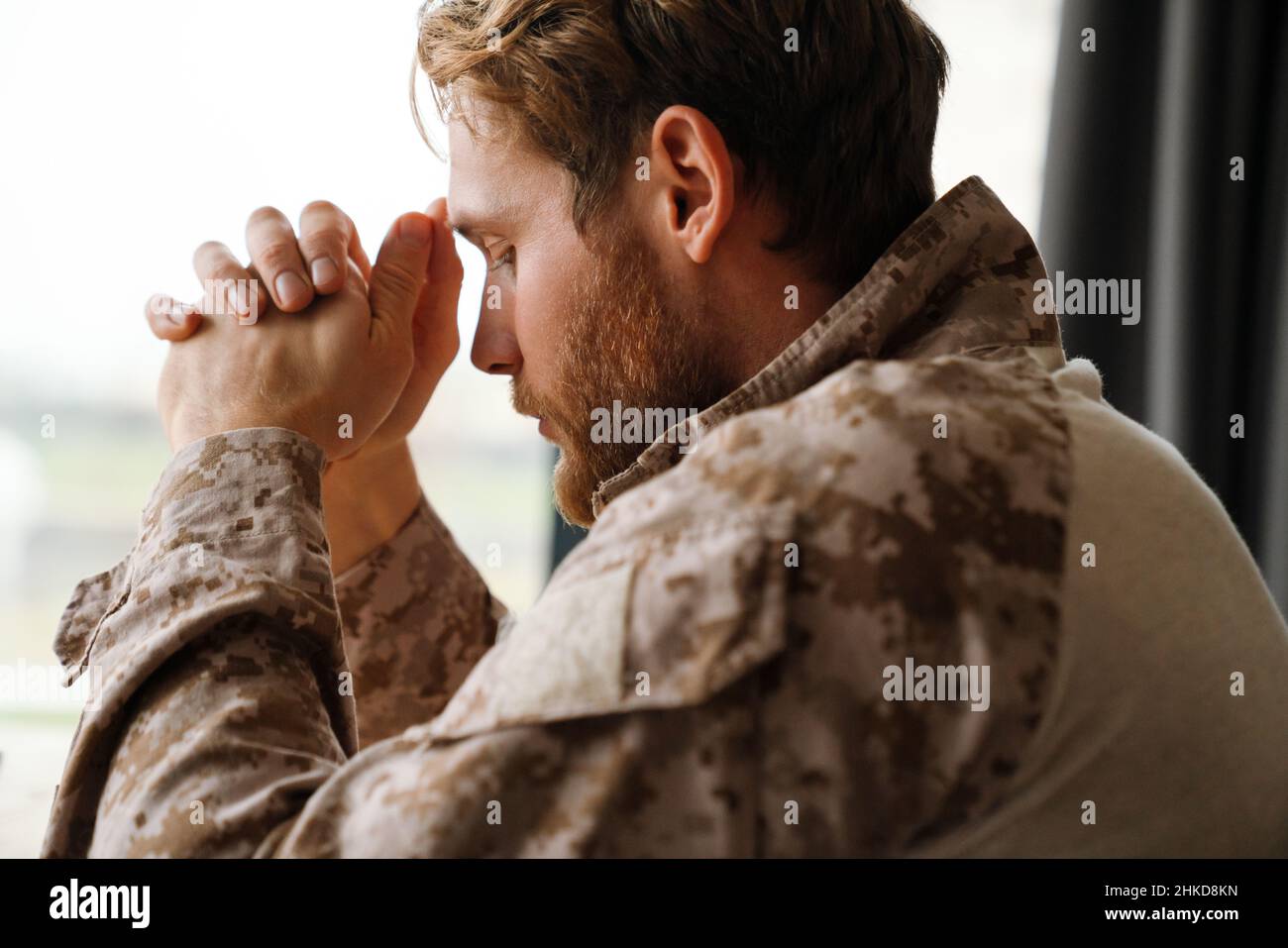 Masculine serious military man thinking while sitting indoors Stock ...