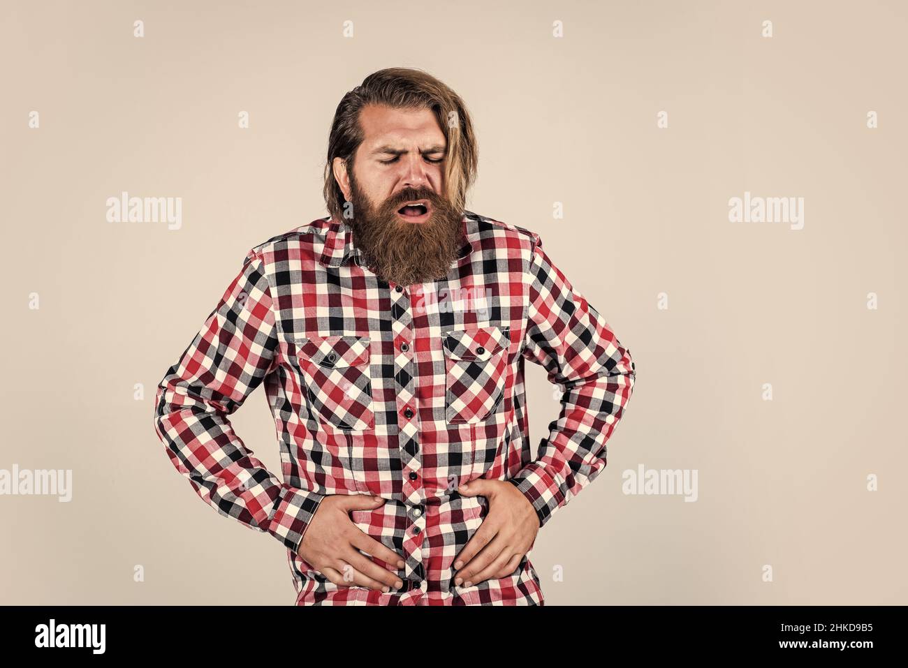 hurt handsome bearded guy with unshaven face and stylish hairdo wear ...