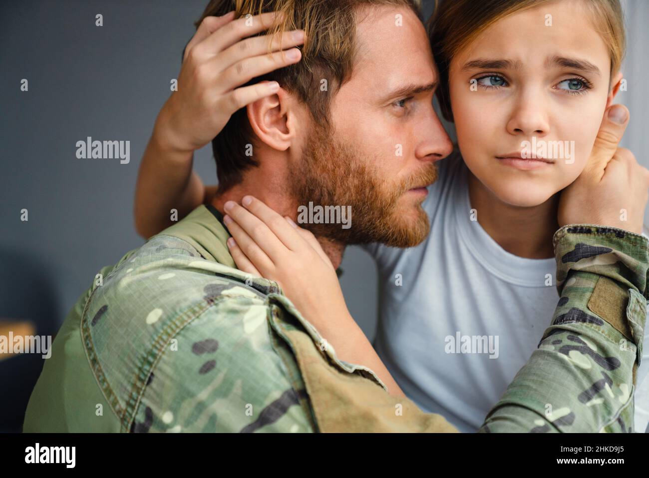 Masculine sad military man hugging her upset daughter indoors Stock ...