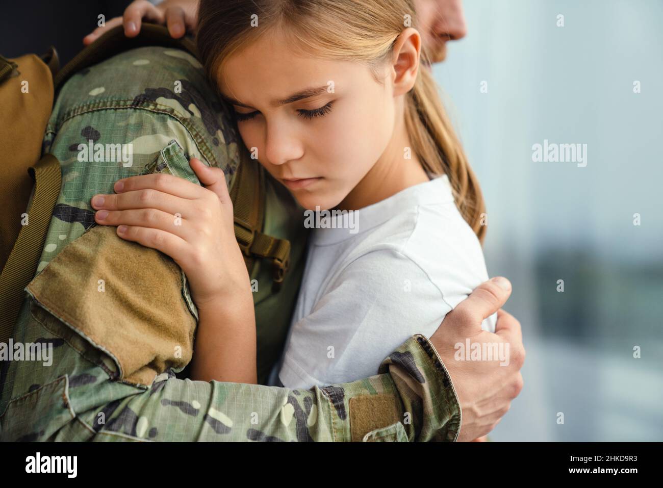 Masculine sad military man hugging her upset daughter indoors Stock ...
