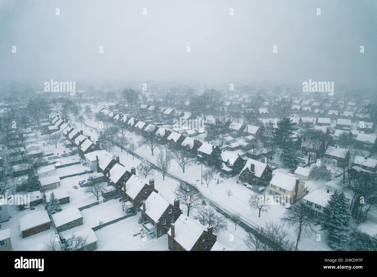 Bird's eye view of houses in symmetric rows covered with snow in winter ...