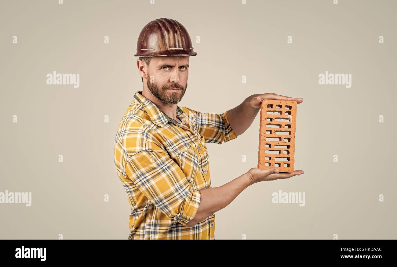 handsome man technician in construction safety helmet and checkered ...