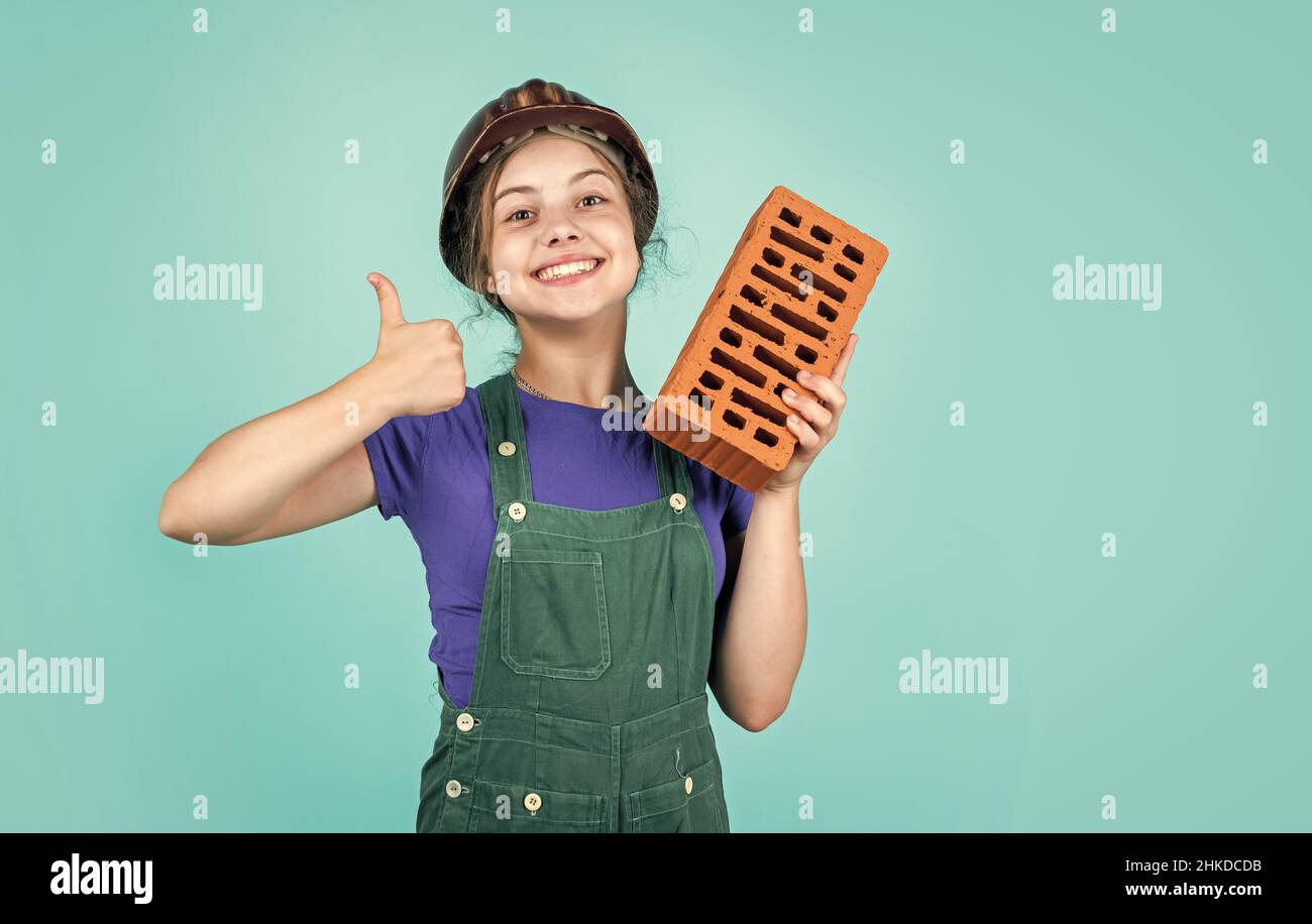 teen girl builder in protective helmet use brick, build future Stock ...